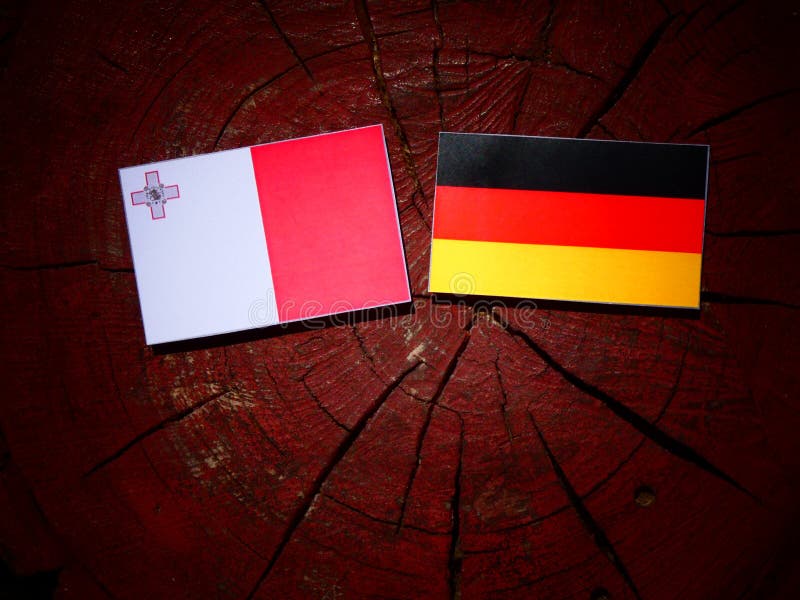 Maltese Flag with German Flag on a Tree Stump Stock Image - Image of ...