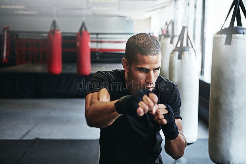 Mama Raised a Fighter. a Kick-boxer Training in a Gym. Stock Image ...