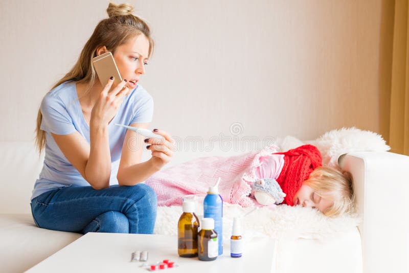 Mère Inquiétée Avec Le Bébé Malade Appelle Le Docteur Image Stock