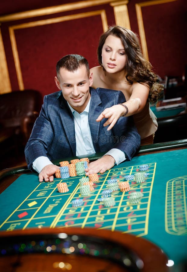 Man Accompanied by Woman at the Casino Table Stock Image - Image of ...