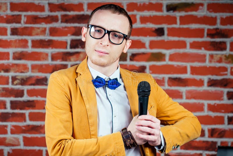 A Man Actor Comedian In Glasses A Stylish And Tie Suit Holds A Microphone Concept Of Public