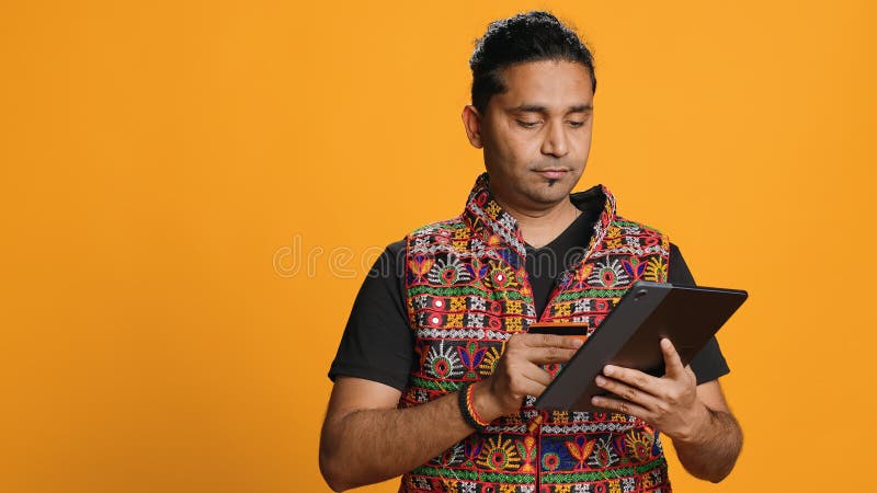 Man Adding Payment Method on Shopping Website Using Tablet, Studio ... Man Adding Payment Method on Shopping Website Using Tablet, Studio ...