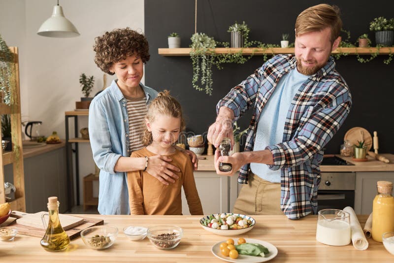 Man adding pepper in salad stock photo. Image of together - 254791266