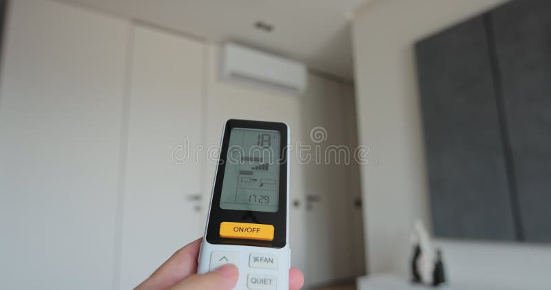 Man Adjust the Temperature on Air Conditioner in the Living Room. Hand ...