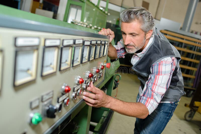 Man Adjusting Controls on Machine Stock Image - Image of care, activate ...