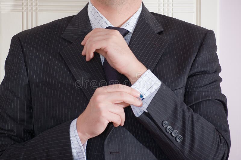 Man Adjusting Cufflink stock photo. Image of executive - 16957802