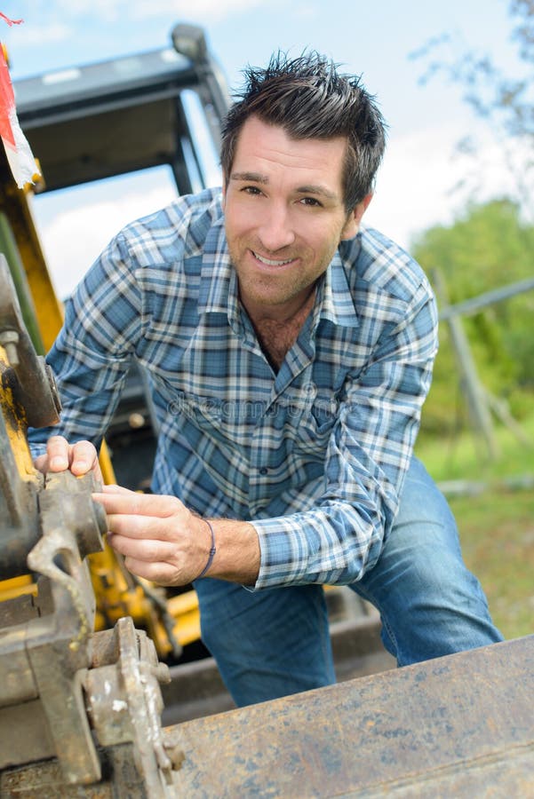 Man Adjusting Linkage on Digger Bucket Stock Photo - Image of smile ...