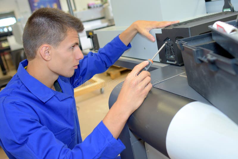 Man Adjusting Machine with Screwdriver Stock Photo - Image of plastic ...