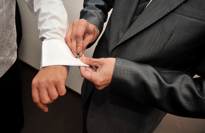 Man adjusting sleeve cuff stock photo. Image of business - 22020018