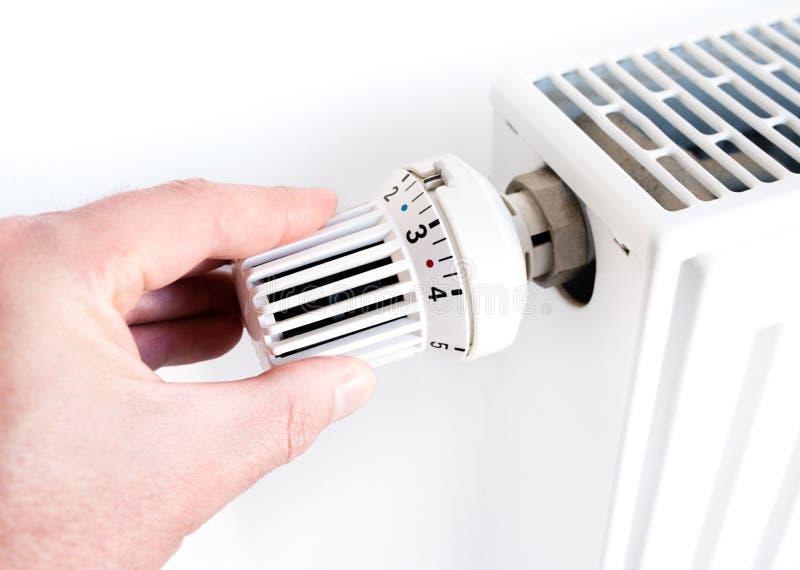 Man Adjusting Temperature on Thermostat on Radiator Stock Photo - Image ...