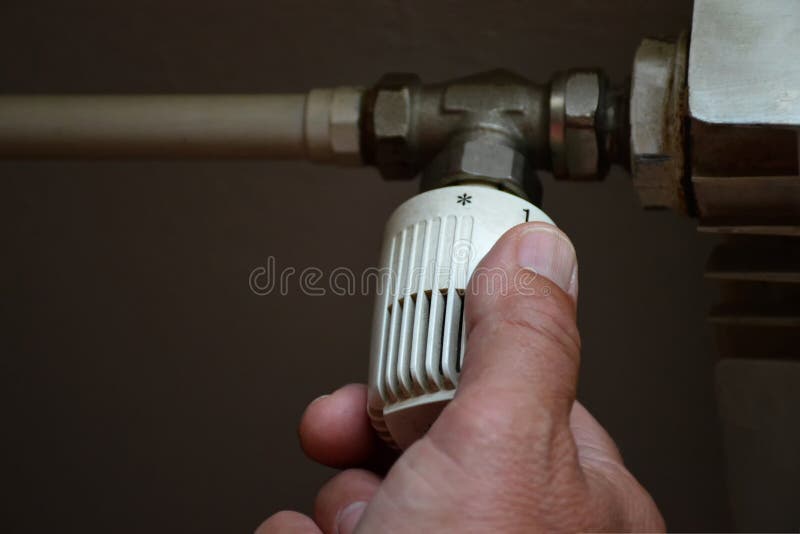 Man Adjusting Thermostatic Radiator Valve, Controlling Central Heating ...