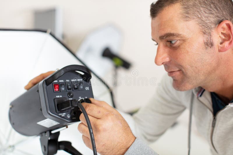 Man Adjusts Professional Studio Lighting Stock Image - Image of ...