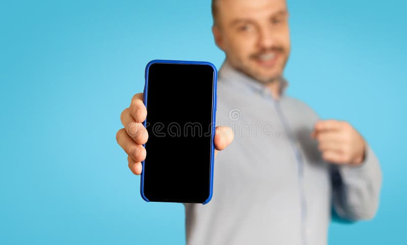 Man Advertising Mobile Offer Showing Smartphone Screen on Blue ...