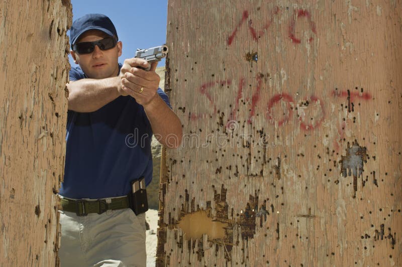 Man Aiming Hand Gun at Firing Range Stock Image - Image of officer ...