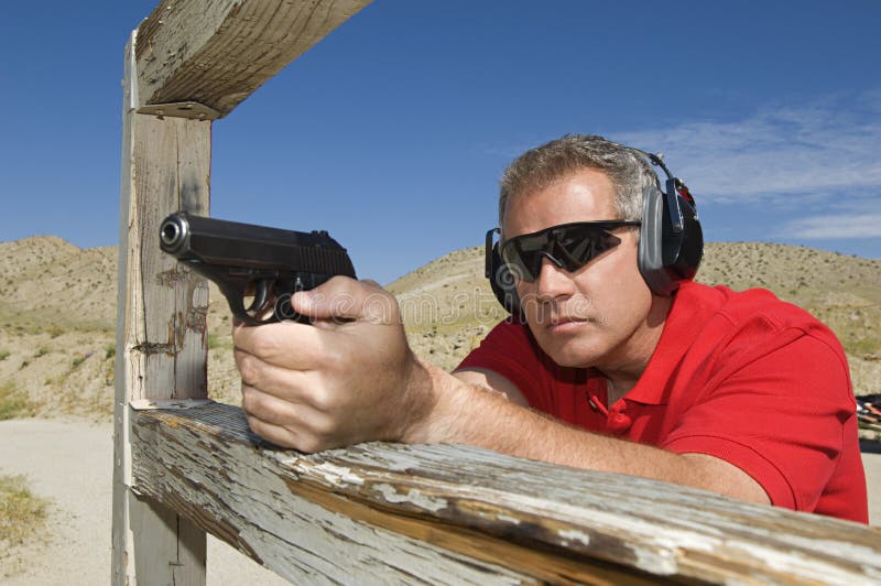 Man Aiming Hand Gun at Firing Range Stock Photo - Image of combat ...