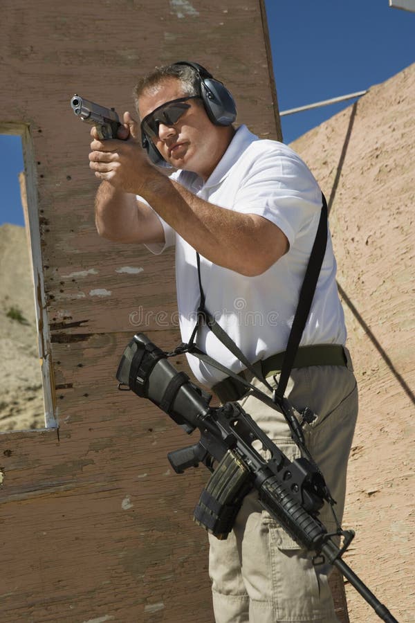 Man Holding Machine Gun at Firing Range Stock Photo - Image of angle ...
