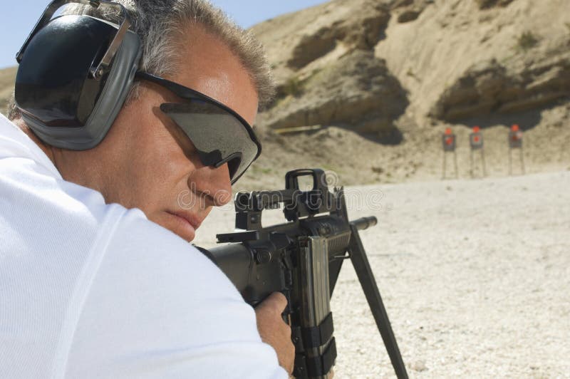 Man Aiming Machine Gun at Firing Range Stock Image - Image of mountain ...