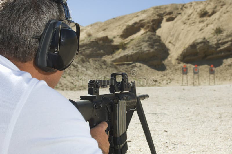 Man Aiming Machine Gun at Firing Range Stock Photo - Image of lying ...