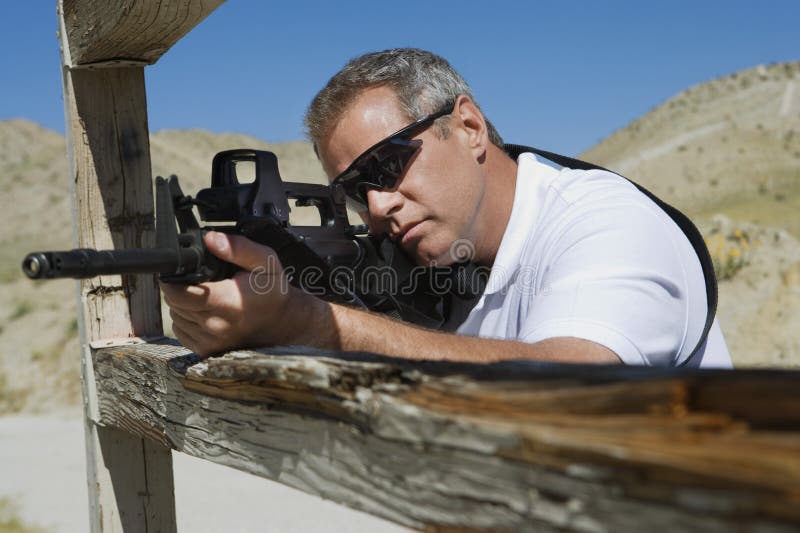 Man Aiming Machine Gun at Firing Range Stock Photo - Image of desert ...
