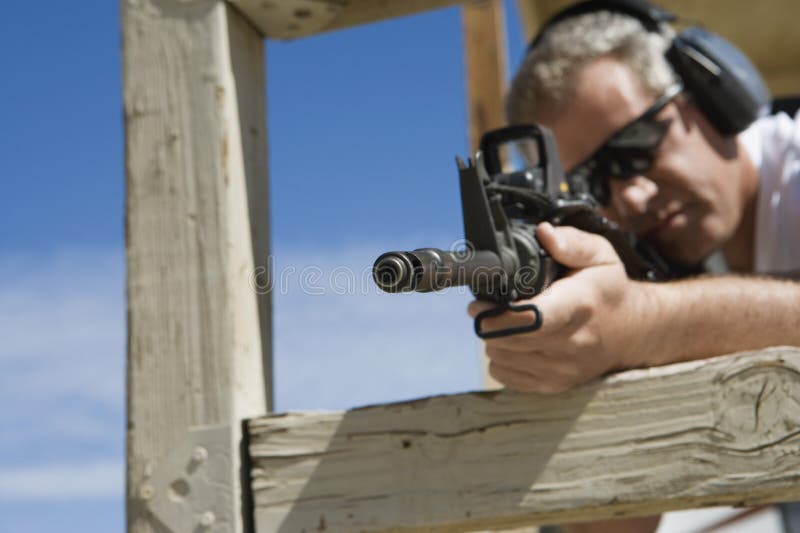 Man Aiming Machine Gun at Firing Range Stock Image - Image of range ...
