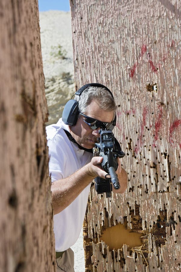 Man Holding Machine Gun at Firing Range Stock Photo - Image of angle ...