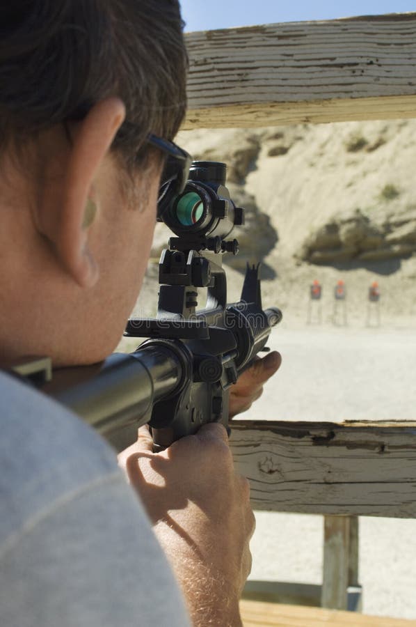 Man Aiming Rifle at Firing Range Stock Image - Image of closeup, rifle ...