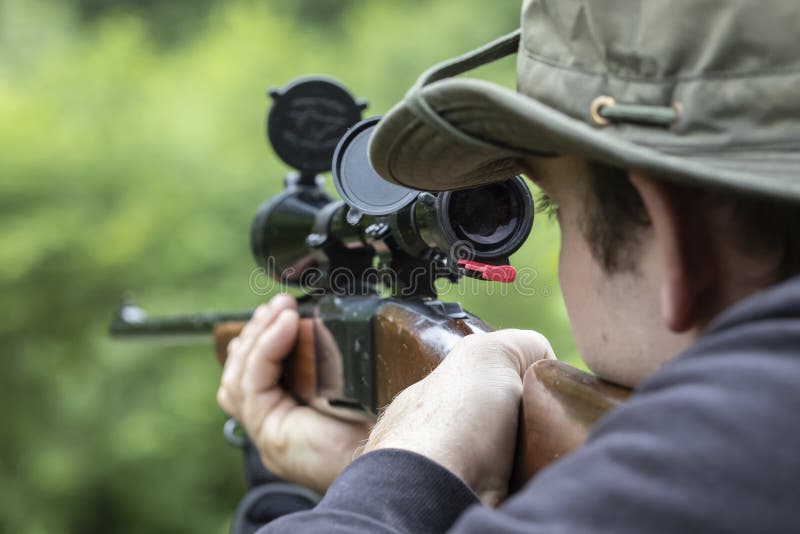 A Man Aiming through a Scope on a Hunting Rifle Stock Photo - Image of ...