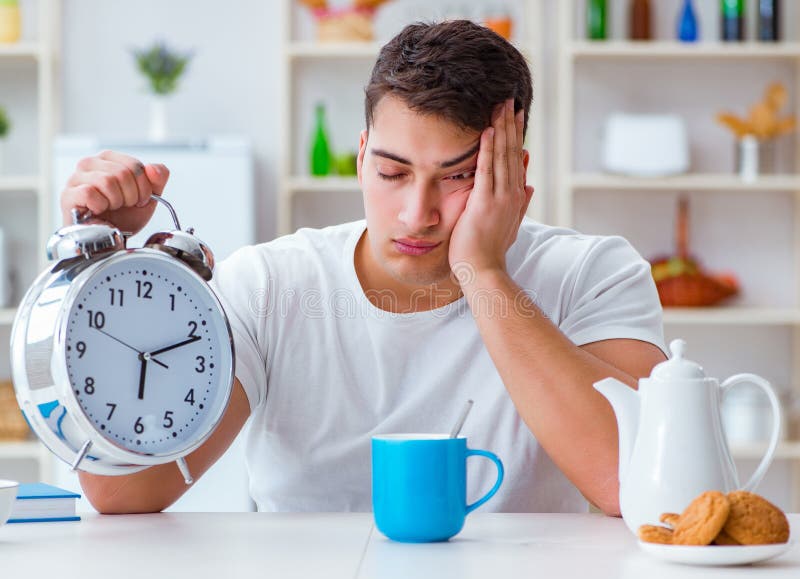 Man with Alarm Clock Falling Asleep at Breakfast Stock Photo - Image of ...