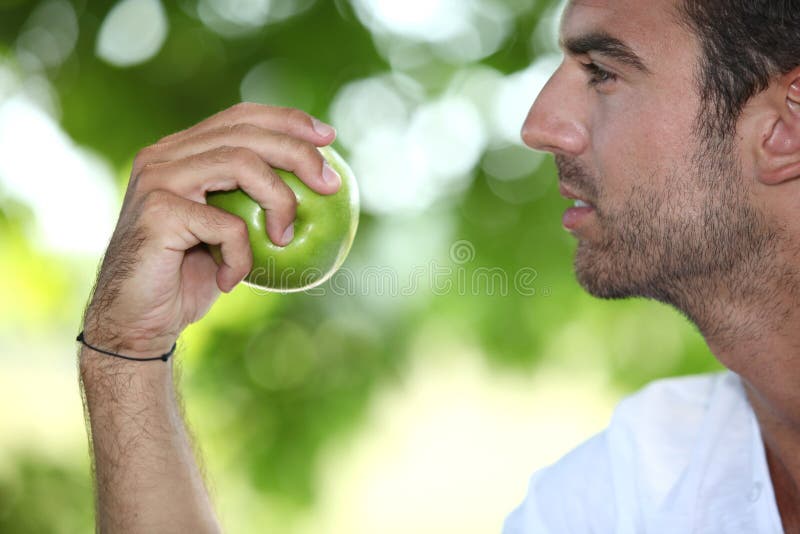 Man with an apple stock image. Image of background, holding - 31379959