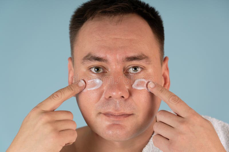 A Man Applies a Face Cream. Skin Care Stock Photo - Image of cream ...