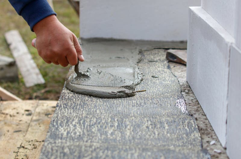 A Man is Applying Cement To a Wall Stock Photo - Image of bricklayer ...