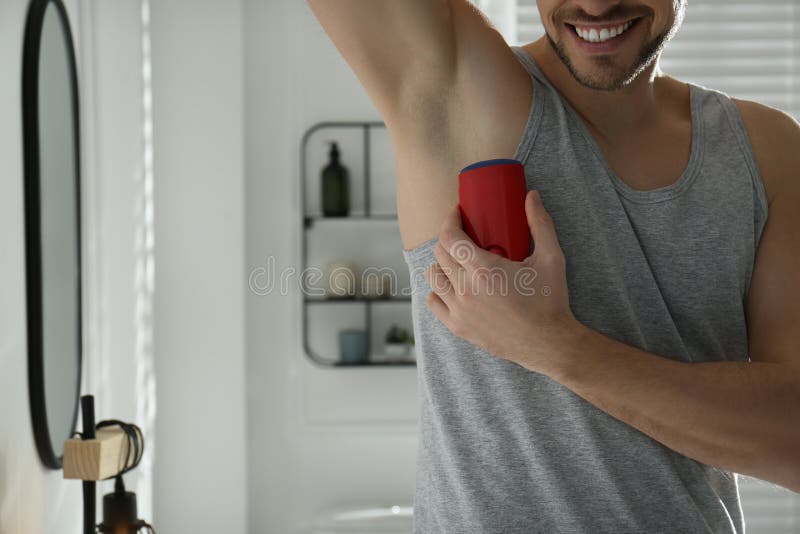 Man Applying Deodorant on Black Background, Closeup. Space for Text ...