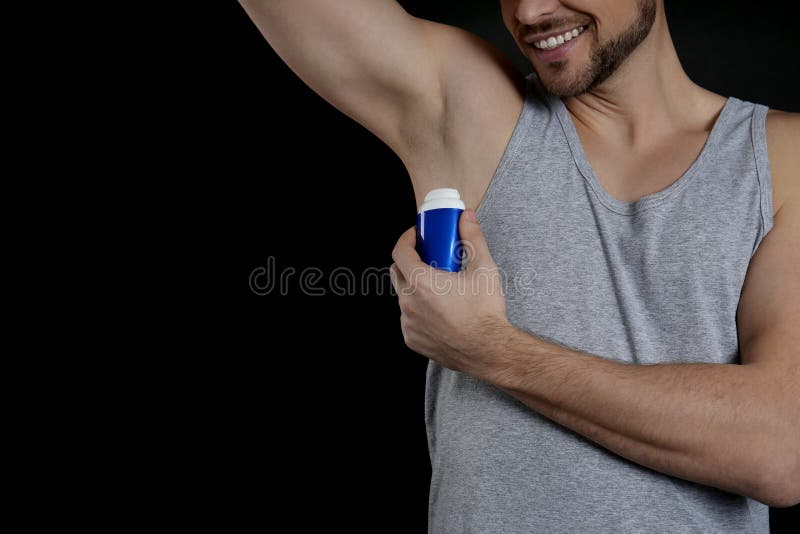 Man Applying Deodorant On Black Background, Closeup. Space For Text ...
