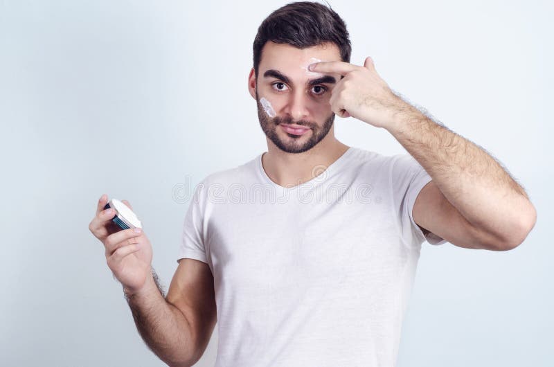 Man Puts Face Cream on Cheeks, Showing Thumbs Up Stock Photo - Image of ...