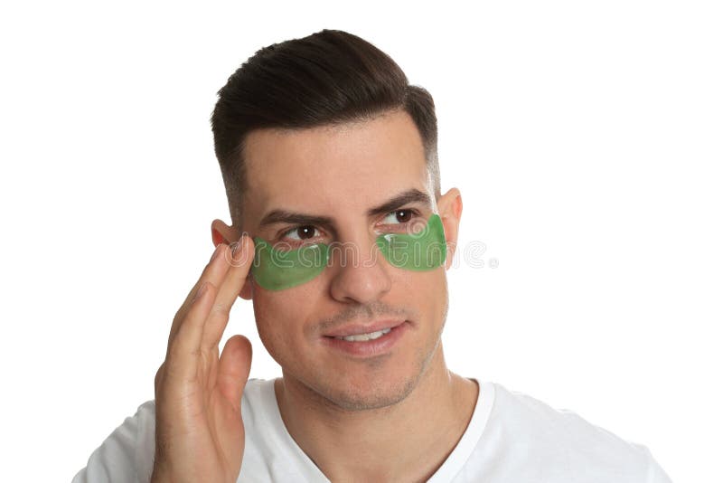 Man Applying Green Under Eye Patch on White Background Stock Image ...