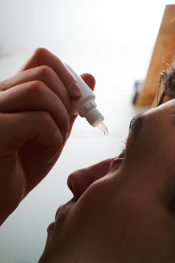 Man is Applying Medical Eye Drops from Eye Wellnesses at Home. Young ...