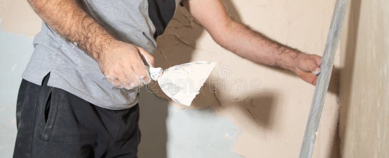 Man is Applying Putty on a Wall. Renovating House Stock Photo - Image ...