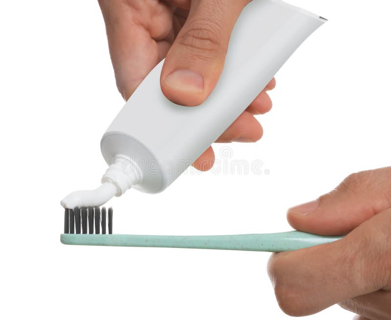 Man Applying Toothpaste on Brush Against White Background, Closeup ...