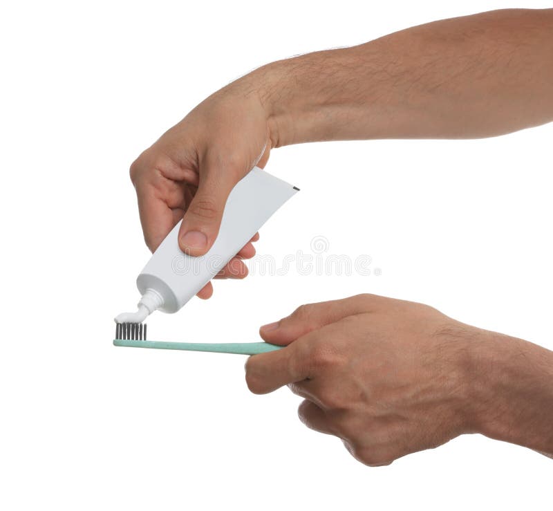 Man Applying Toothpaste on Brush Against White Background, Closeup ...
