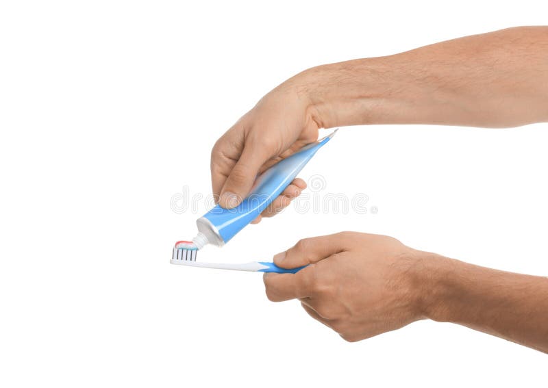 Man Applying Toothpaste on Brush Against White Background, Closeup ...
