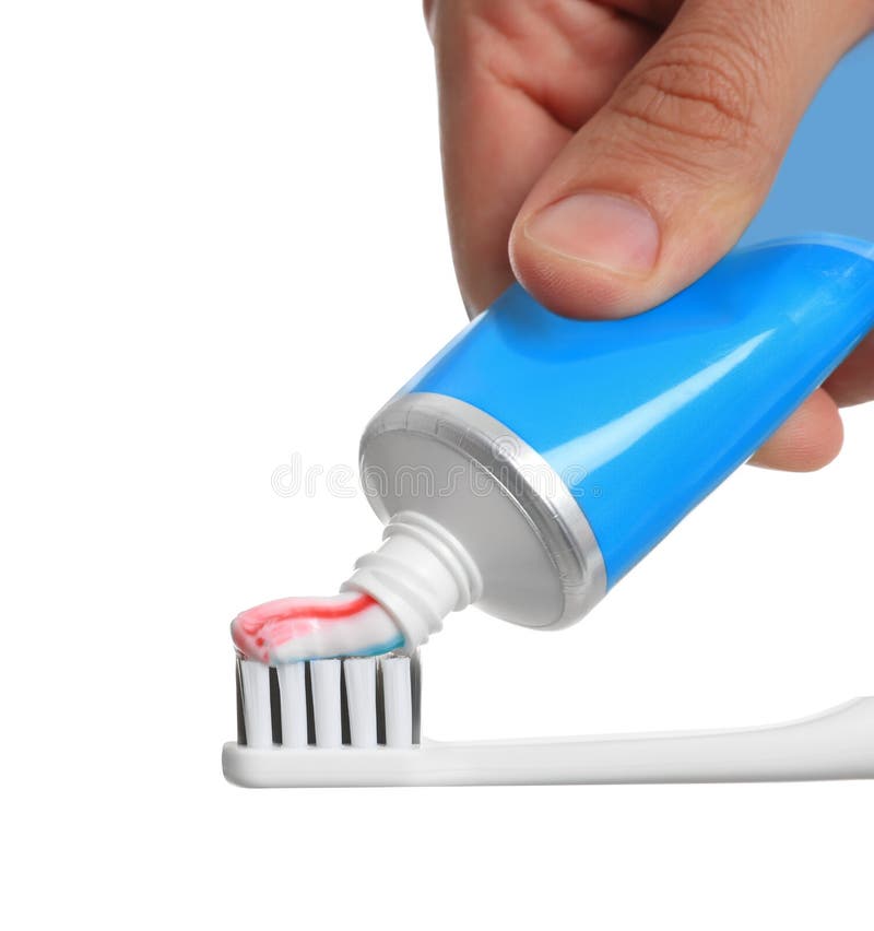 Man Applying Toothpaste on Brush Against White Background, Closeup ...