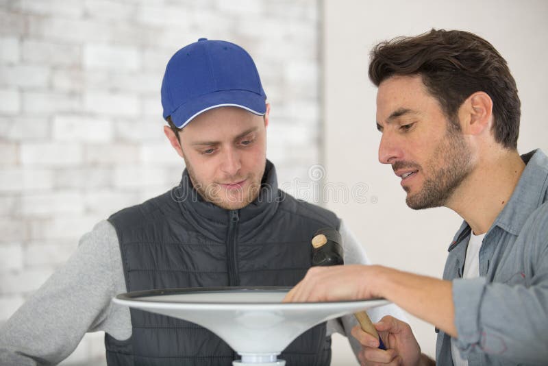 Man with Apprentice Assembling Metal Stool Stock Image - Image of ...