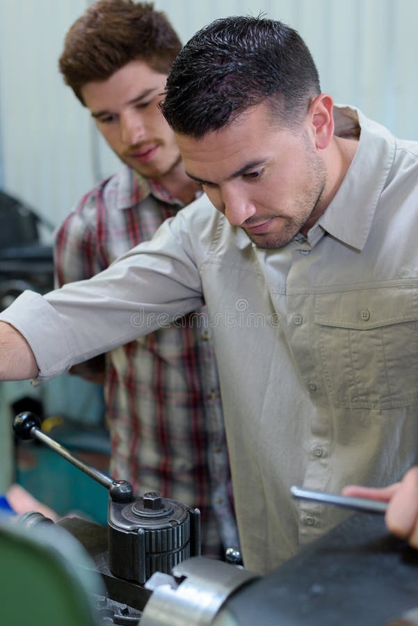 Man with Apprentice Looking at Engine Stock Photo - Image of mechanic ...
