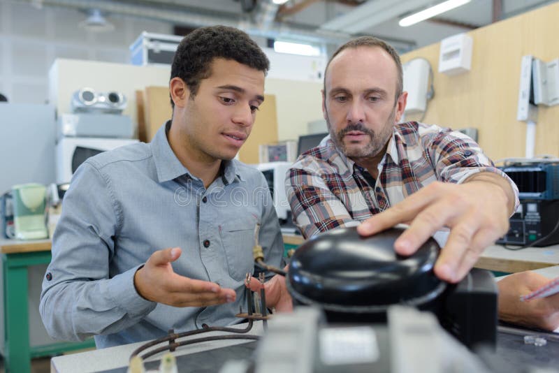 Man and Apprentice Watching Printing Machine Stock Photo - Image of ...