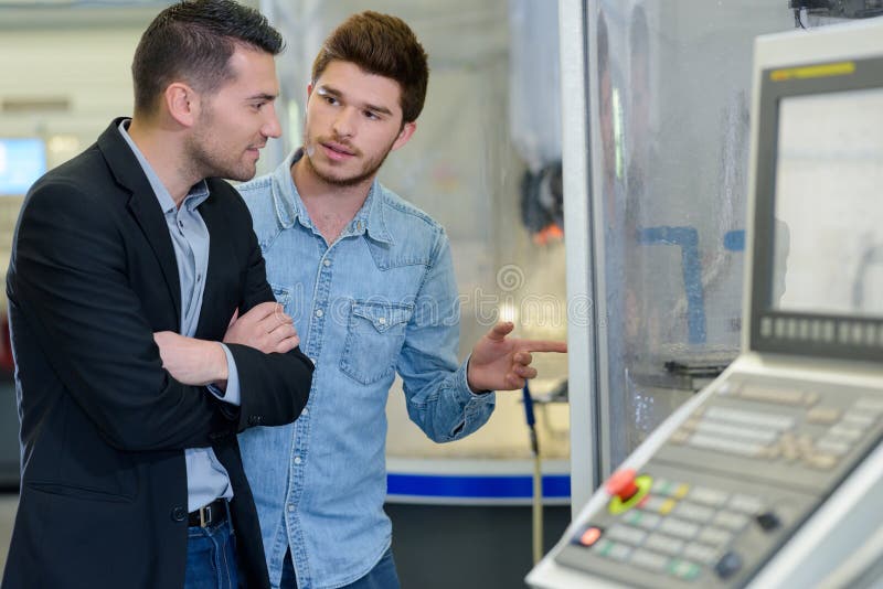 Man and Apprentice Working on Printing Machine Stock Image - Image of ...