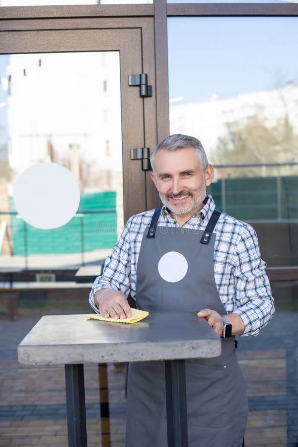 Man in Apron Cleaning the Tables in a Street Cafe Stock Image - Image ...