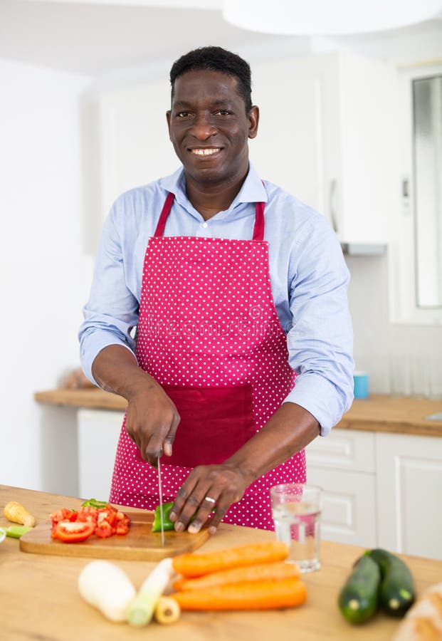 Man in Apron Making Dinner at Kitchen Table Stock Image - Image of ...