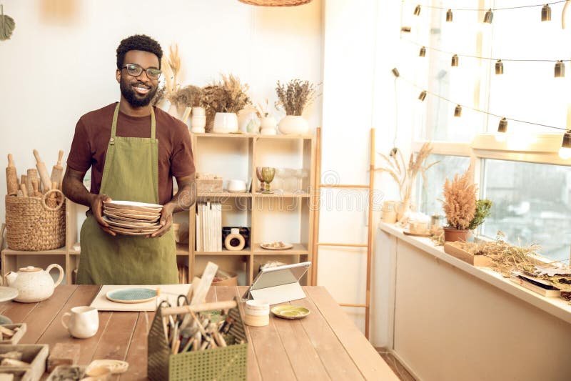 Man in Apron Standing with Ceramic Plates in Hands Stock Photo - Image ...