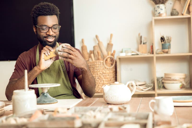 Man in Apron Working in the Pottery Studio and Looking Involved Stock ...