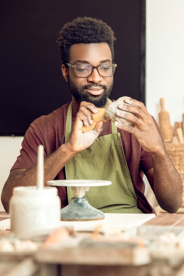 Man in Apron Working in the Pottery Studio and Looking Involved Stock ...